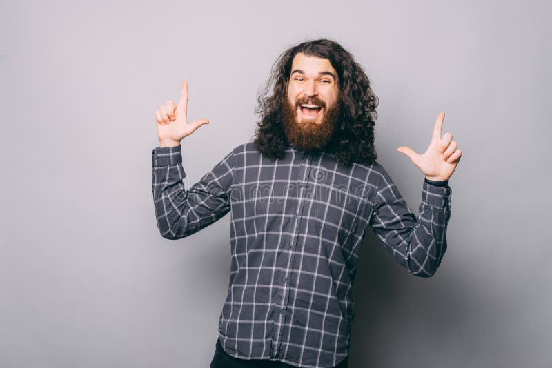 Hey Look at this. Amazed Young Man with Beard Pointing Up and Screaming ...