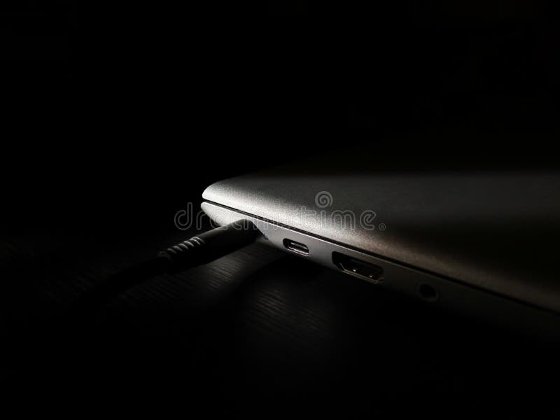 The Hi-tech Notebook is Connected To the Adapter Charging Port in Black ...