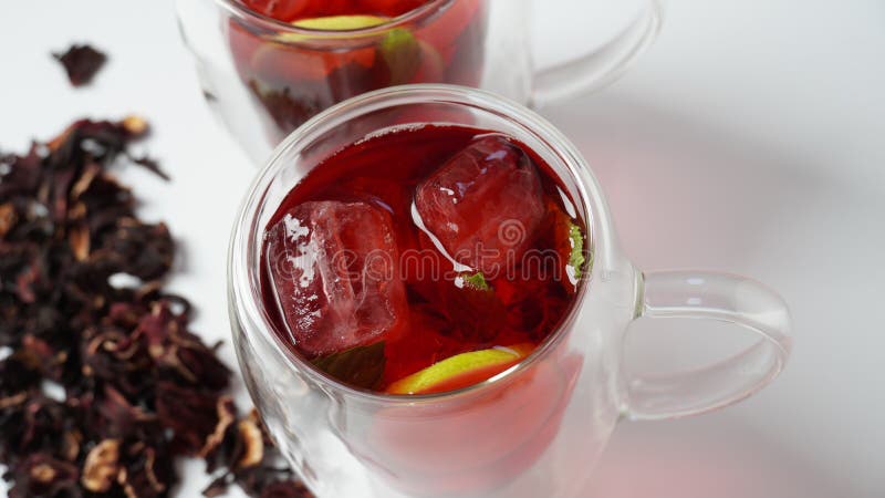 Hibiscus Cold Tea Drink with Ice Cubes and Lemon in Glass Stock Image ...