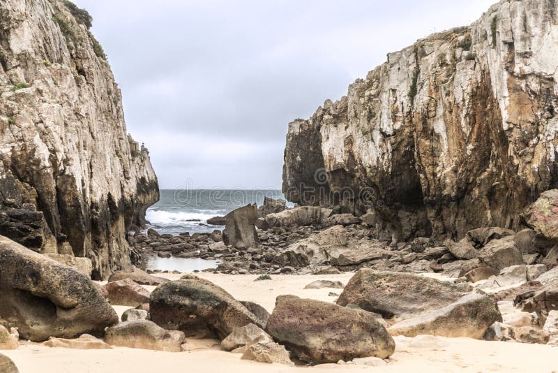 Hidden Beach in the Middle of Two Cliffs on a Cloudy Day Stock Image ...
