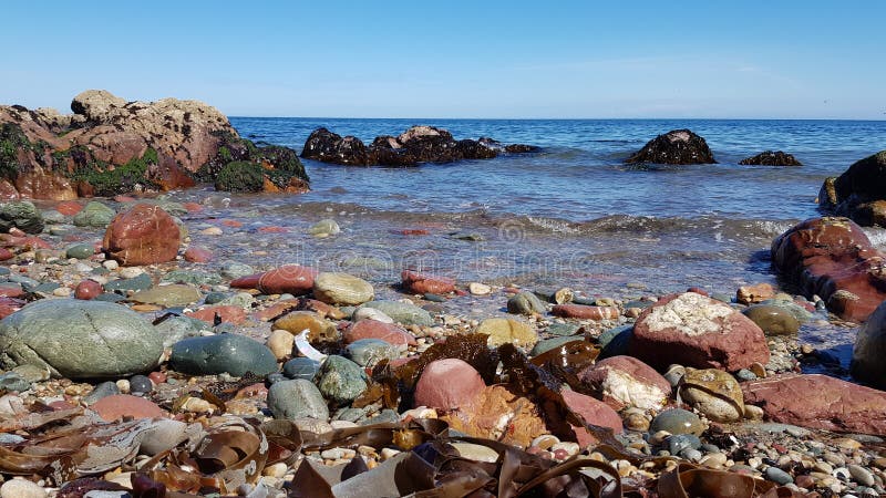 Hidden Beach with Red Rocks in Howth Ireland Stock Photo - Image of ...