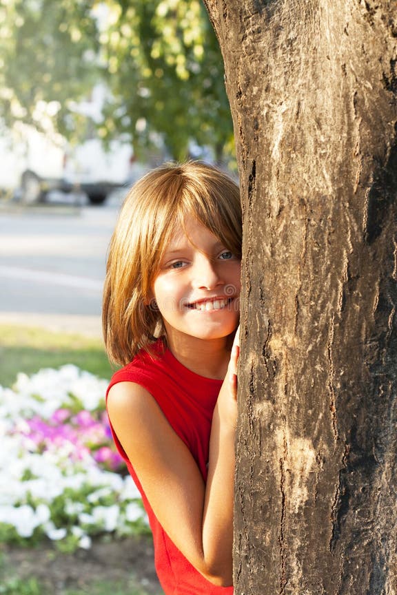 Hidden behind the tree stock image. Image of expression - 32056921
