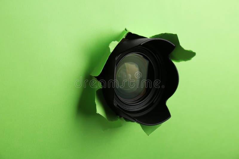 Hidden Camera Lens through Torn Hole in White Paper Stock Image - Image ...