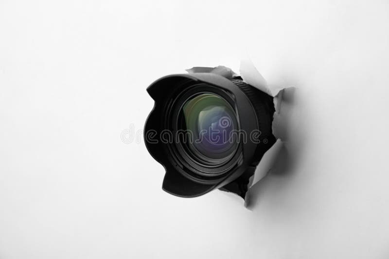 Hidden Camera Lens through Torn Hole in White Paper Stock Photo - Image ...