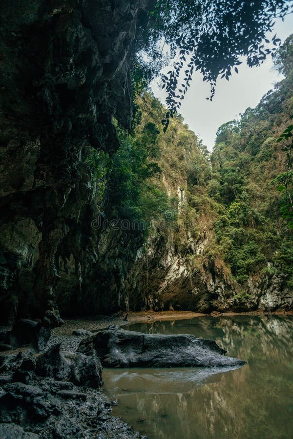 A Hidden Cave Features Smooth Rock Formations Surrounded by Dense ...