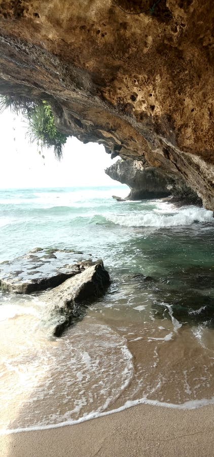 Hidden cave beside the sea stock photo. Image of water - 283164964