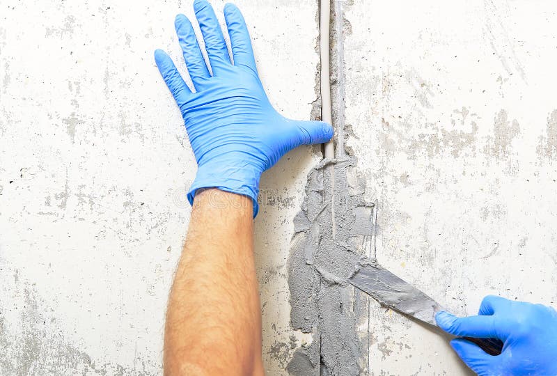 Hidden Installation of Electrical Wires for Sockets To a Concrete Wall ...