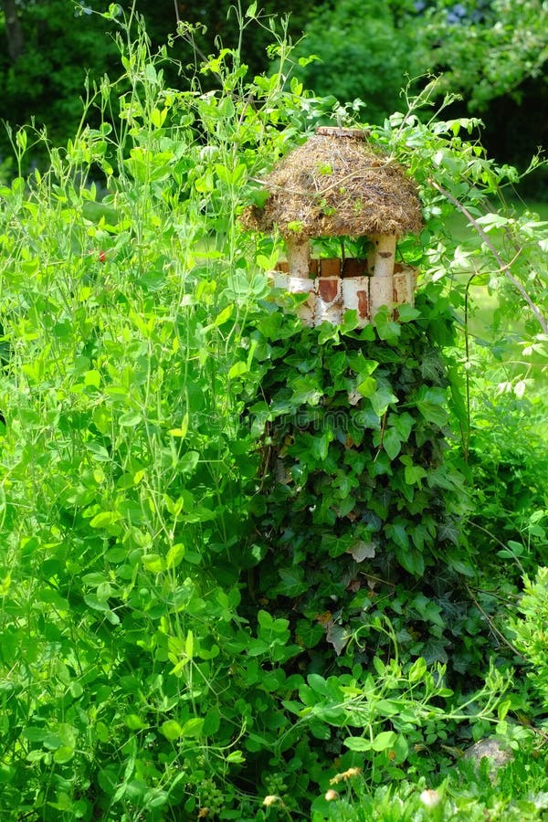 Hidden Treasures in a Rustic Garden. an Ornament in a Lush Green Garden ...