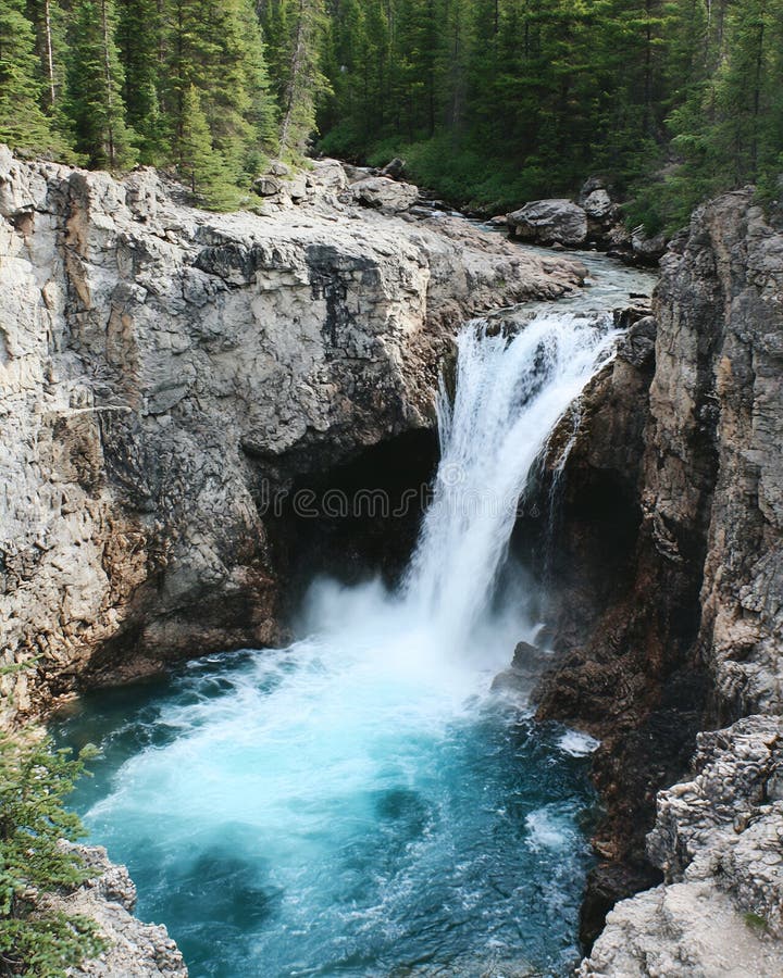 A Secluded Cascade Tumbling into a Jewel-like Azure Basin. Stock ...