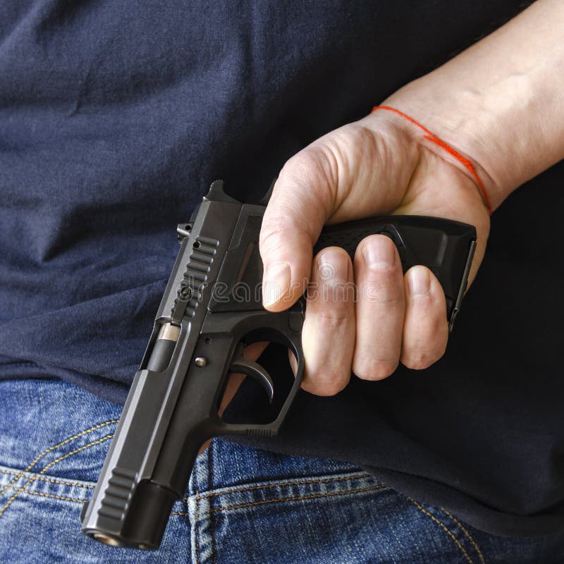 Hidden Weapons. a Pistol in His Hand Behind the Man& X27;s Back ...