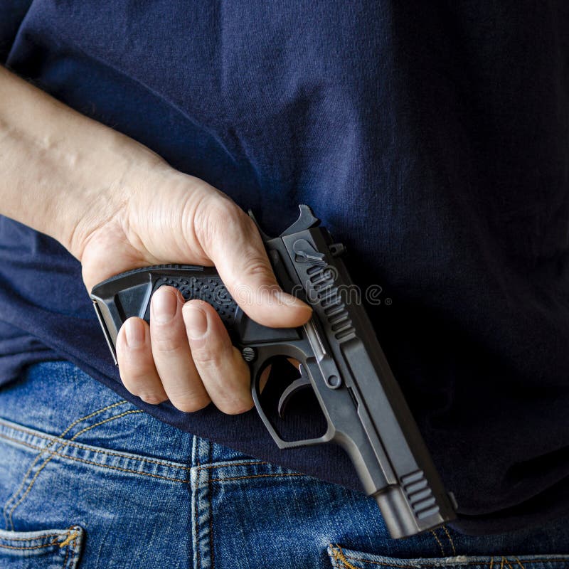 Hidden Weapons. a Pistol in His Hand Behind the Man& X27;s Back ...
