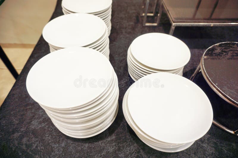 High Angel of Stacks of Many Clean and Shiny Soft White Plates Stock ...