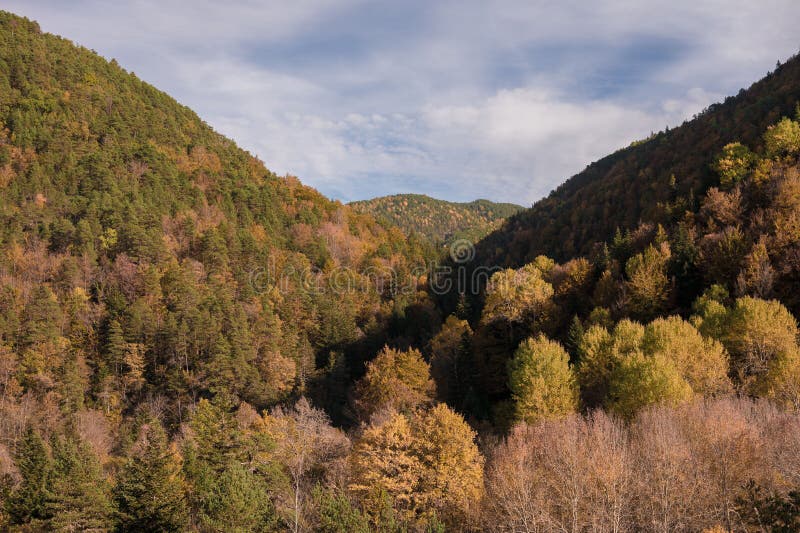 High-angle of Autumn Forested Mountains on a Sunny Day with Cloudy Sky ...