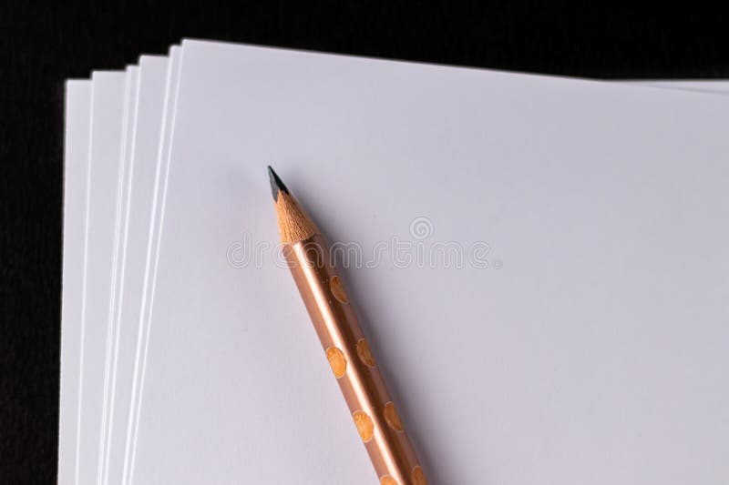 High Angle Close Up Shot of a Pencil Placed Diagonally Over White ...