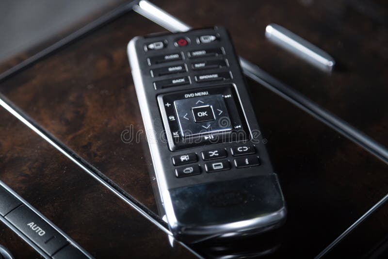 High Angle Closeup Shot of a DVD Remote Control Inside a Modern Car ...