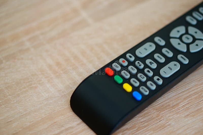 High Angle Closeup Shot of a Remote Controller on a Wooden Surface ...
