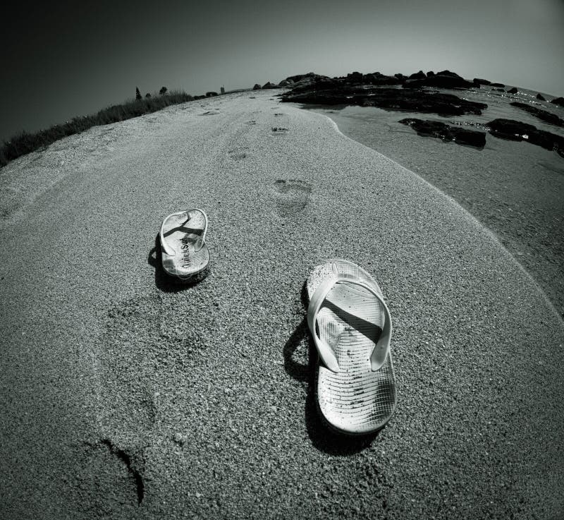 High-angle Grayscale View of Flip-flops on the Sand Editorial ...