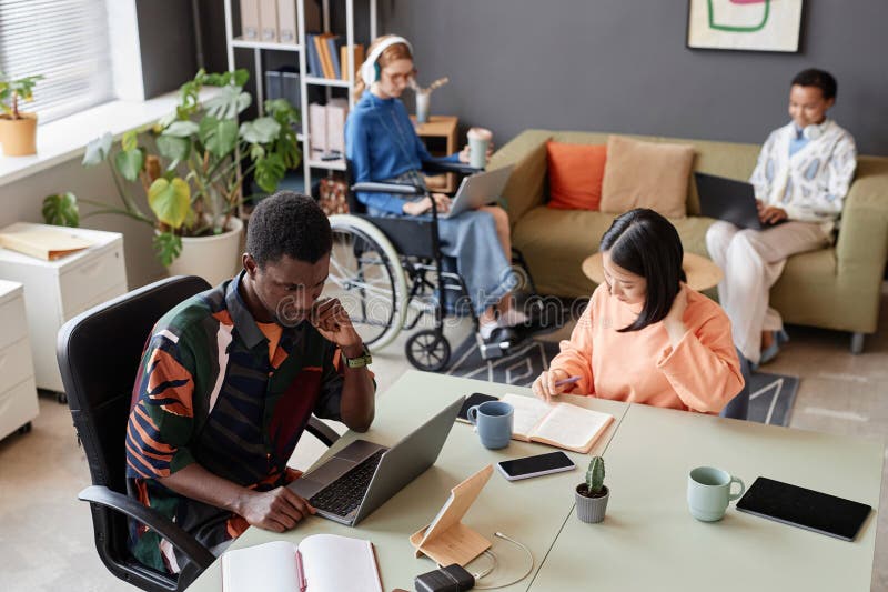 Black Young Man Using Laptop Computer in Office with Diverse Team Stock ...