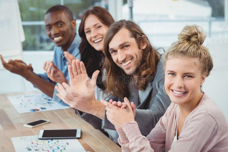 High Angle Portrait Of Smiling Business People Clapping At Desk Stock ...