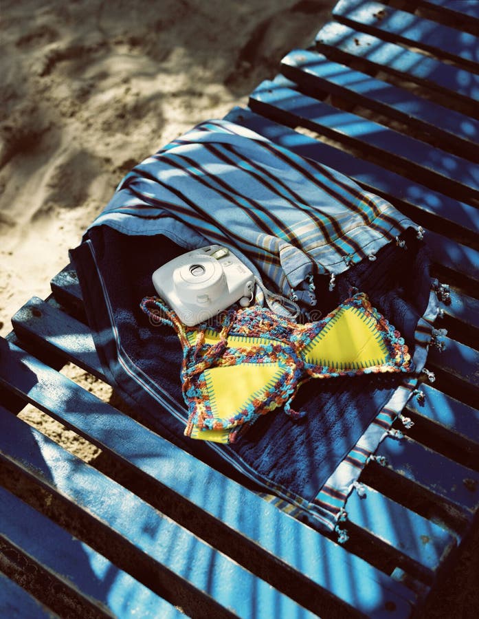 High-angle Shot of a Beach Scene with a Towel, Camera and Bikini Stock ...
