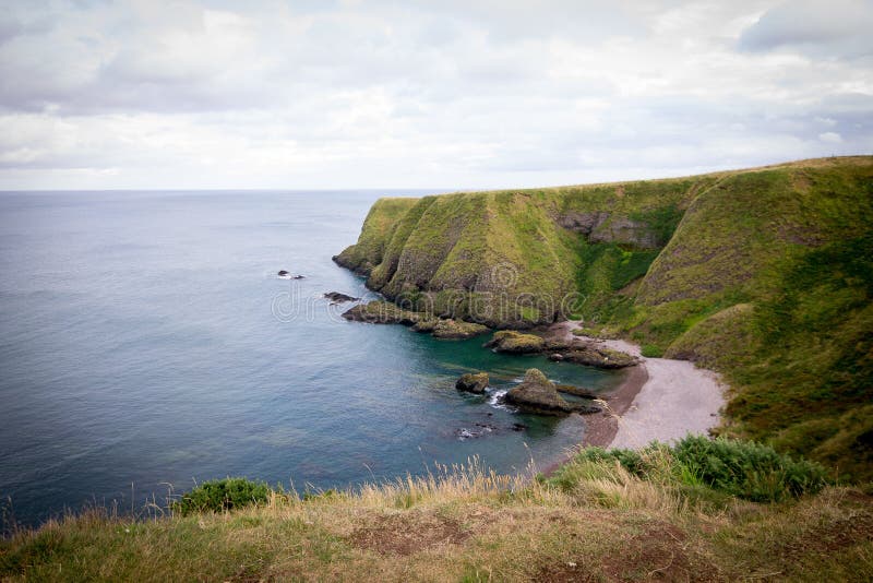 High Angle Shot of the Beautiful Grass-covered Cliffs by the Ocean ...