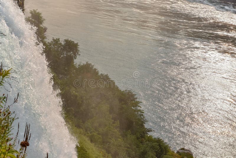 High Angle Shot of a Beautiful Waterfall Over the Trees on the Lake ...