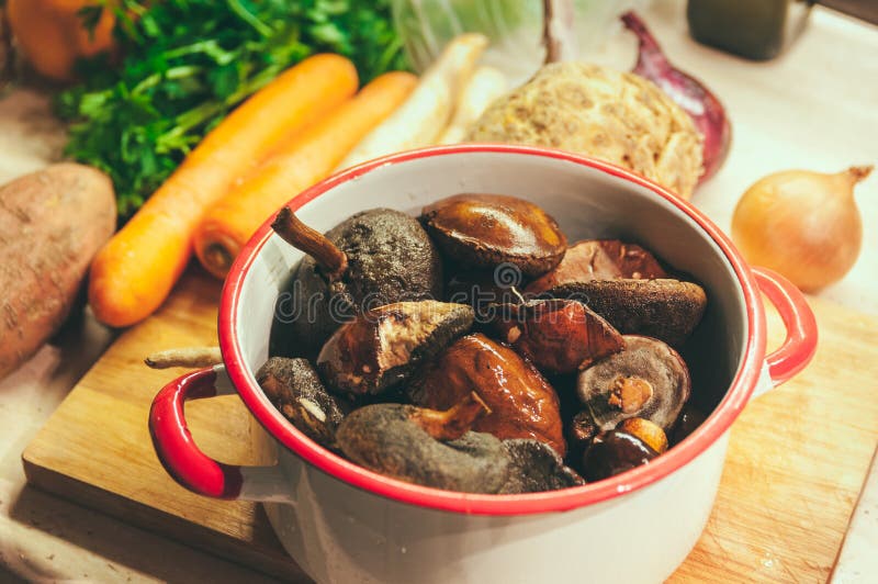 High Angle Shot of Boiled Fig in a White Metal Pot on a Chopping Board ...
