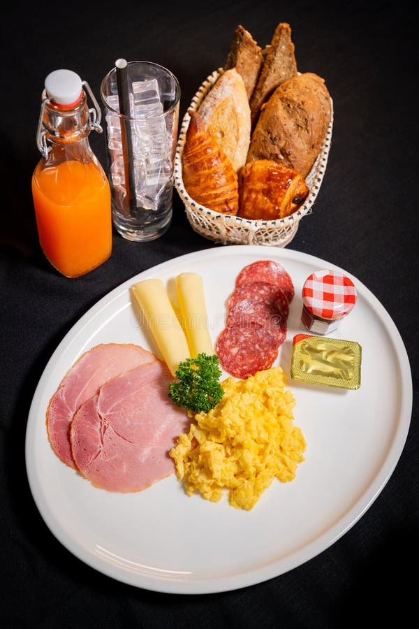 Breakfast Spread on a Plate, Include Scrambled Eggs, Slices of Ham ...