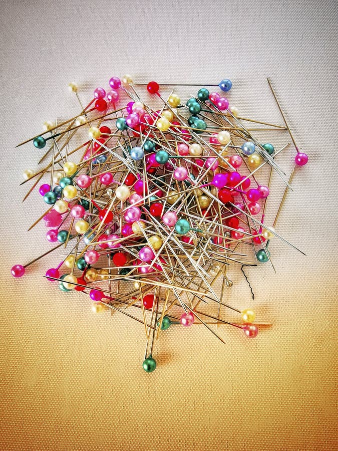 High Angle Shot of Colorful Sewing Needle Pins on a White Fabric Stock ...