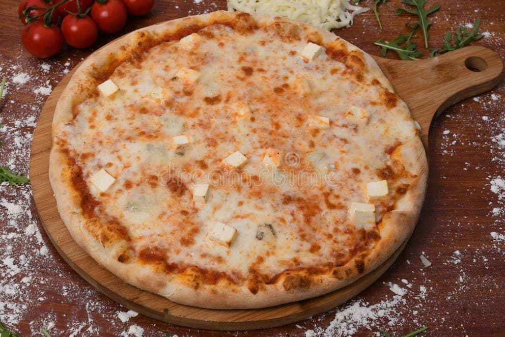High Angle Shot of a Delicious Cheese Pizza on a Messy Kitchen Table ...