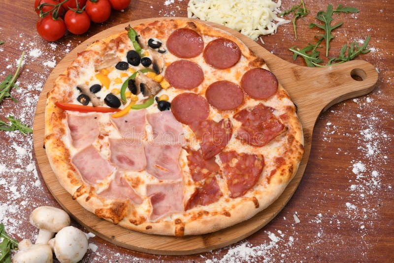 High Angle Shot of a Delicious Pizza Divided into Four Parts with ...