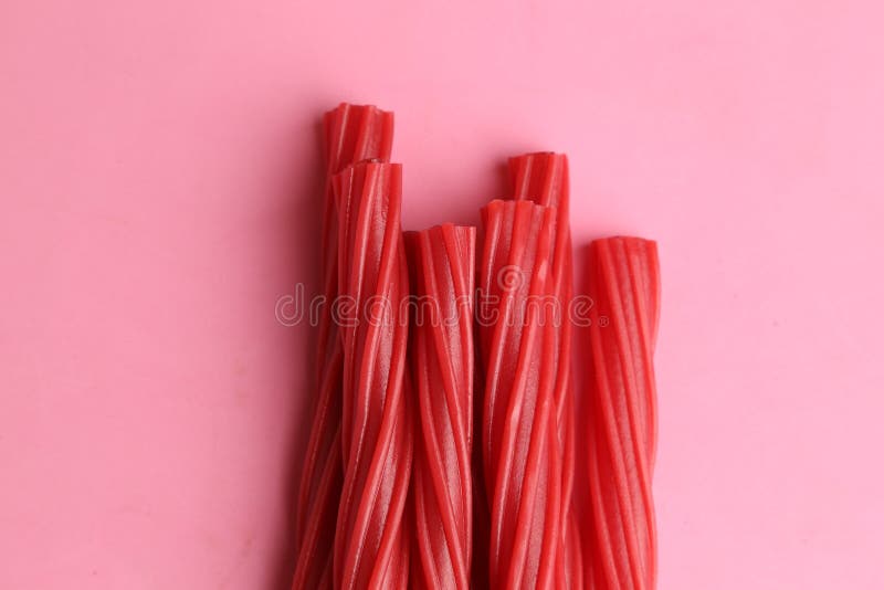 High Angle Shot of Delicious Stick Candies Isolated on a Pink Surface ...