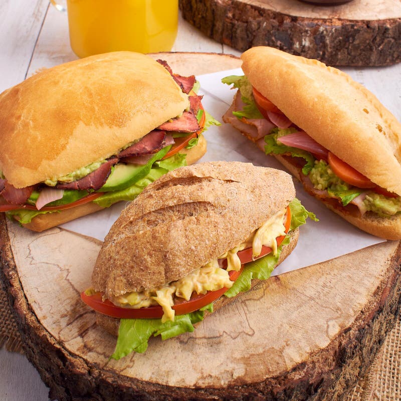 High-angle Shot of Different Types of Sandwiches on a Wooden Log Piece ...