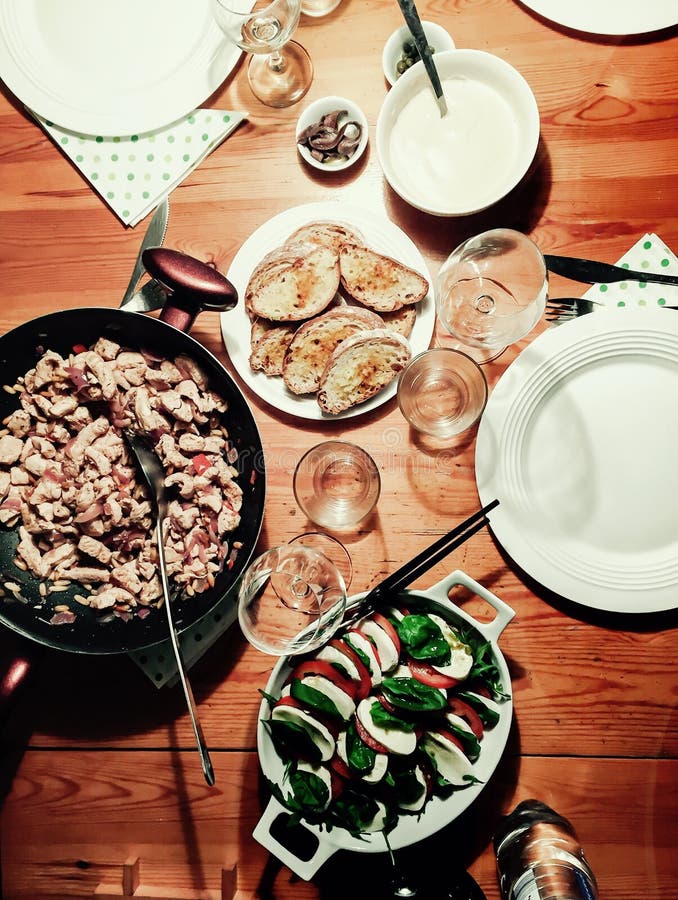 High Angle Shot of a Dinner Table Setting with Grilled Meat and Salad ...