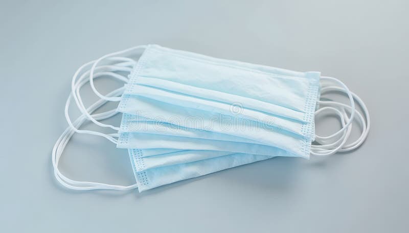 Stack of Light Blue Surgical Masks on Gray Background for Medical ...