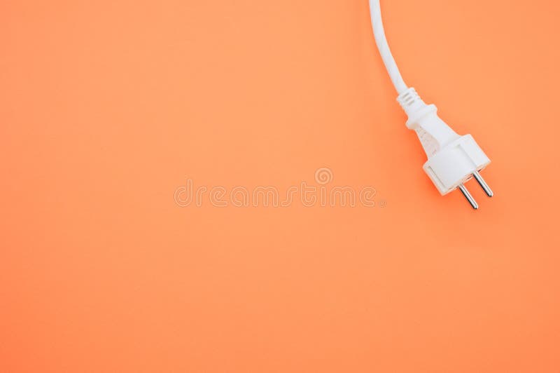 High Angle Shot of an Electrical Wire and Plug on an Orange Surface ...