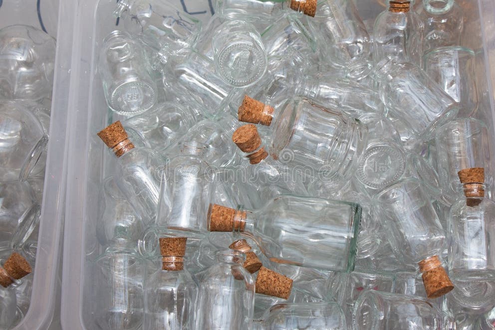 High Angle Shot of Empty Glass Bottles with Cork on a Plastic Container ...