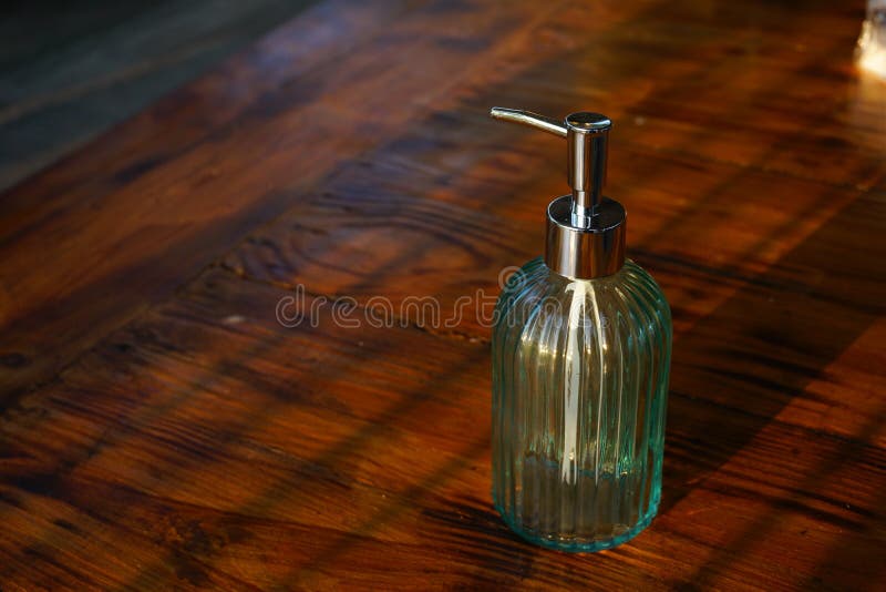 High Angle Shot of an Empty Soap Container on a Wooden Surface Captured ...