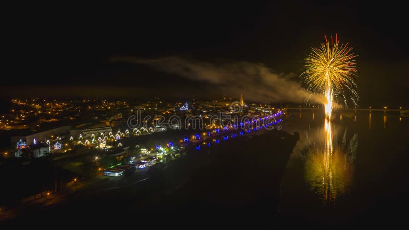 High Angle Shot of Fireworks Near Buildings at Night Time Stock Photo ...