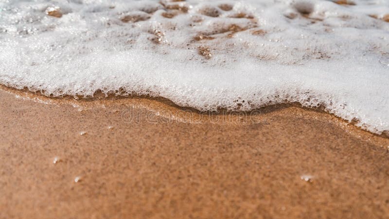 High Angle Shot of the Foamy Waves Coming Towards the Sandy Beach Stock ...