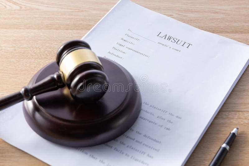 High Angle Shot of a Gavel and Lawsuit Papers on a Wooden Surface Stock ...