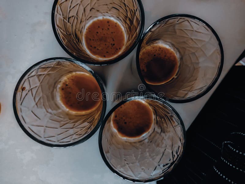 High Angle Shot of Glass Cups Filled with Some Coffee on the Bottom ...