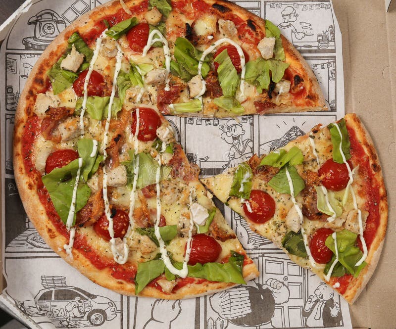 High Angle Shot of a Gourmet Pizza with Various Toppings on a Messy ...