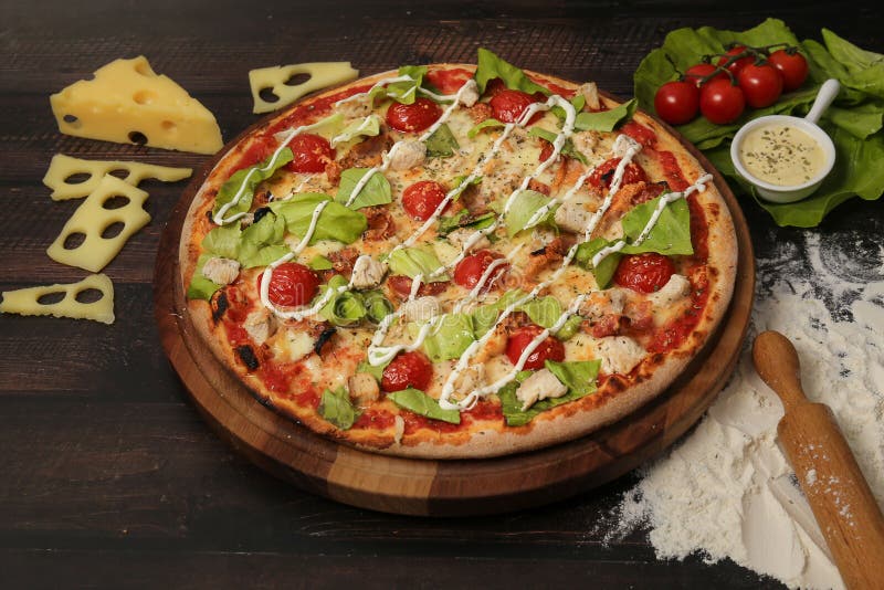 High Angle Shot of a Gourmet Pizza with Various Toppings on a Messy ...