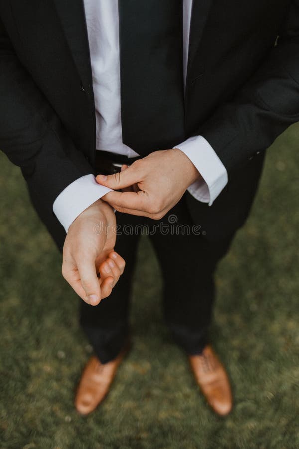 High Angle Shot of the Groom S Hands Fixing His Cuffs while Standing in ...