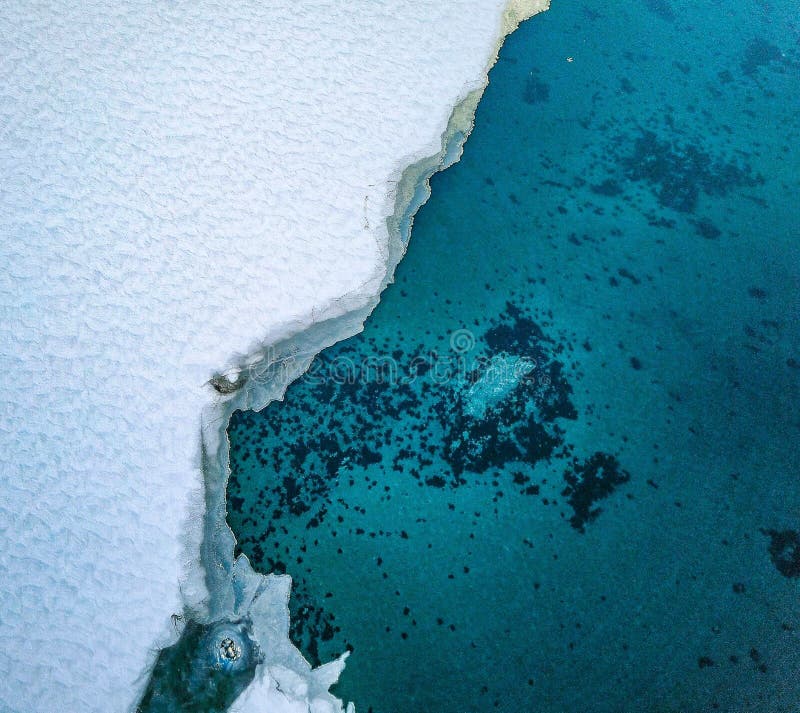 High Angle Shot of a Half of a Water Surface and a Half of Ice Covered ...