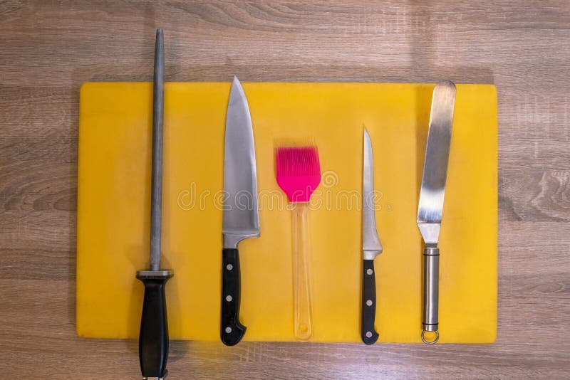 High Angle Shot of a Kitchen Cooking Tools Placed on a Yellow Chopping ...