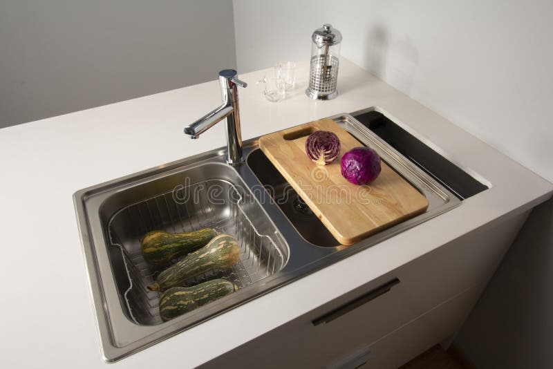 High Angle Shot of a Kitchen Sink with Squash and a Cutting B Stock ...