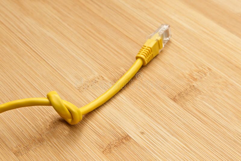 High Angle Shot of a Knotted Yellow Cable on a Wooden Surface Stock ...