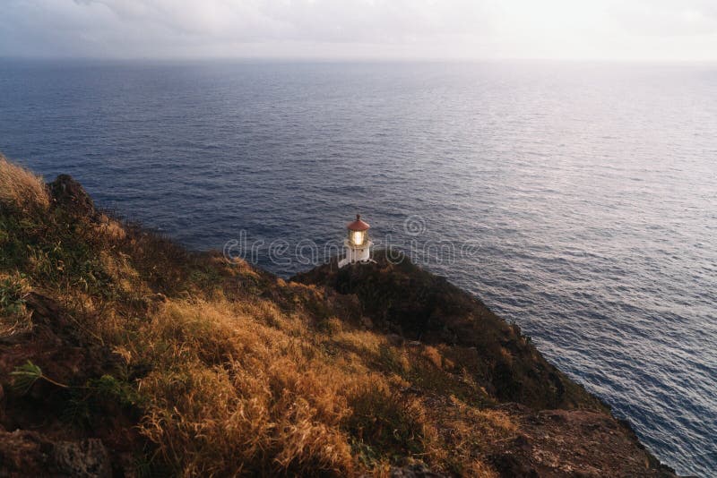 High Angle Shot of a Lighthouse at the Top of the Cliff in the Ocean ...